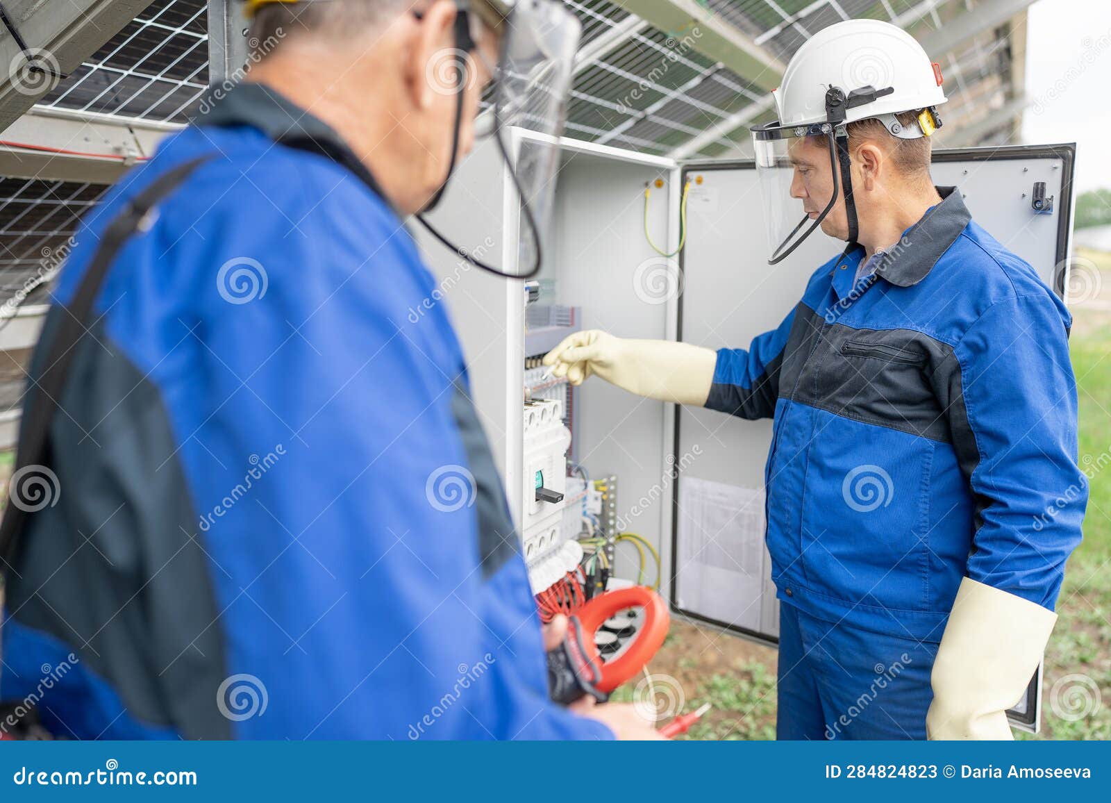 Two Service Engineers or Electrician Working on Checking Transformer ...