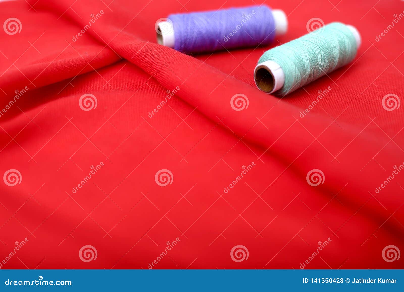 Two Sewing Thread on the Red Cloth Stock Photo - Image of colored ...