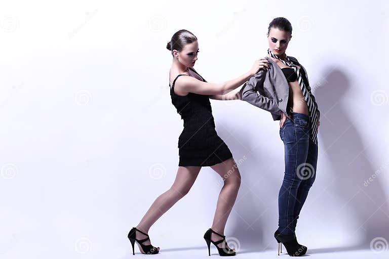 Two women posing in studio stock image. Image of adult - 25687857