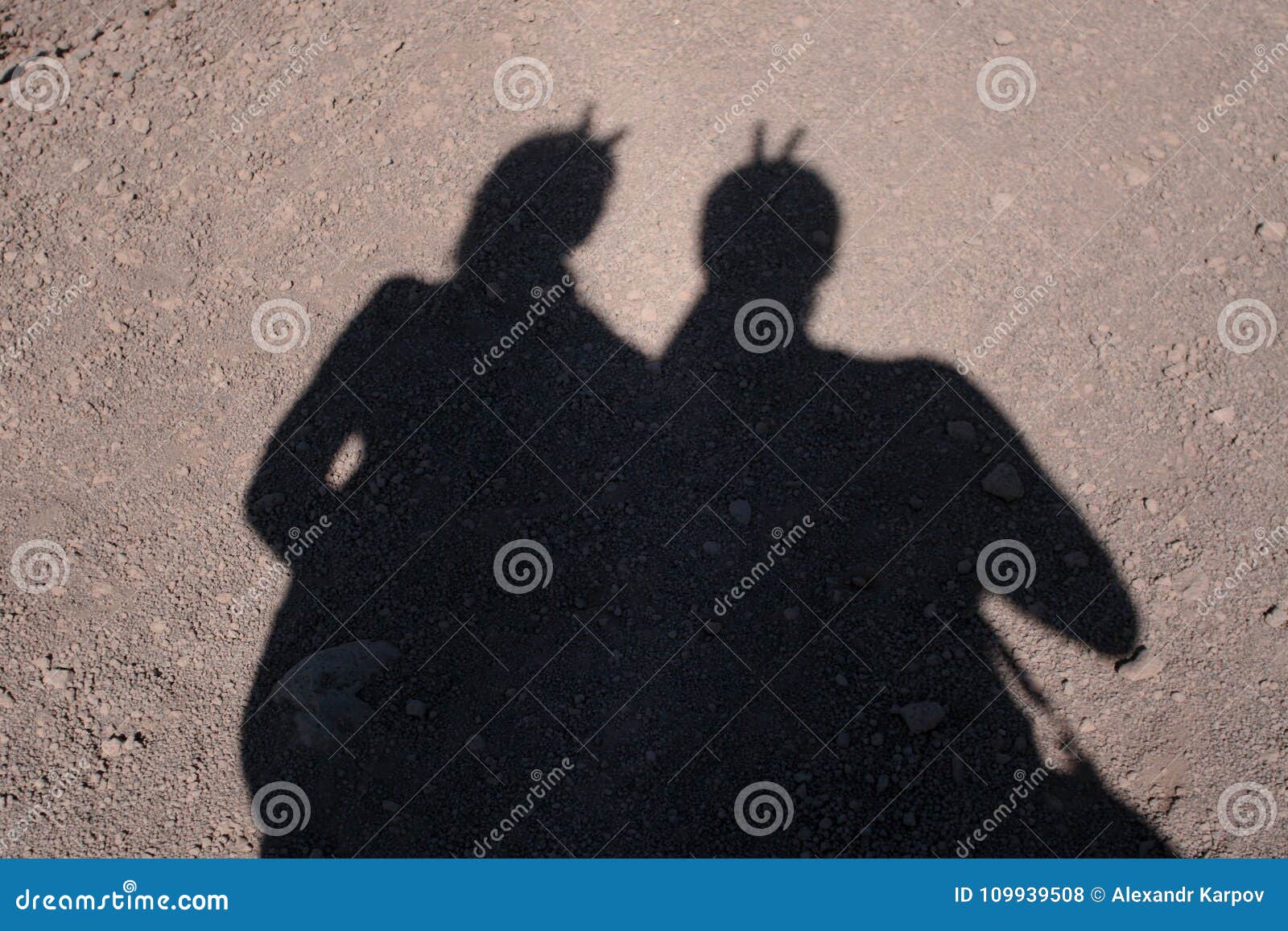 Two shadows on the road stock photo. Image of person - 109939508