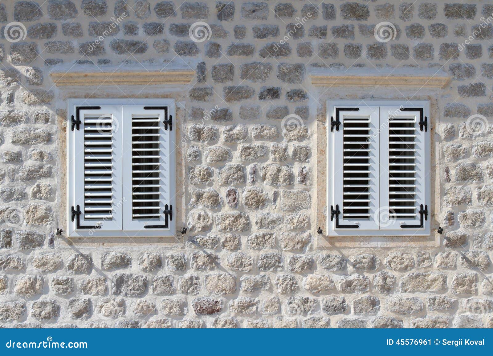 Two Shuttered Windows in the Stone Wall of the House Stock Image ...