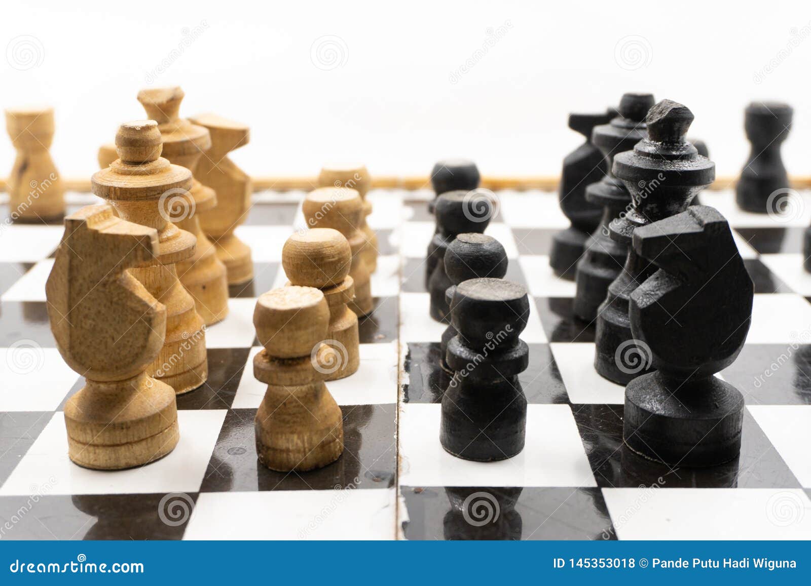 Two Sides of Black and White Chess Pieces, Which are Made of Wood, are ...