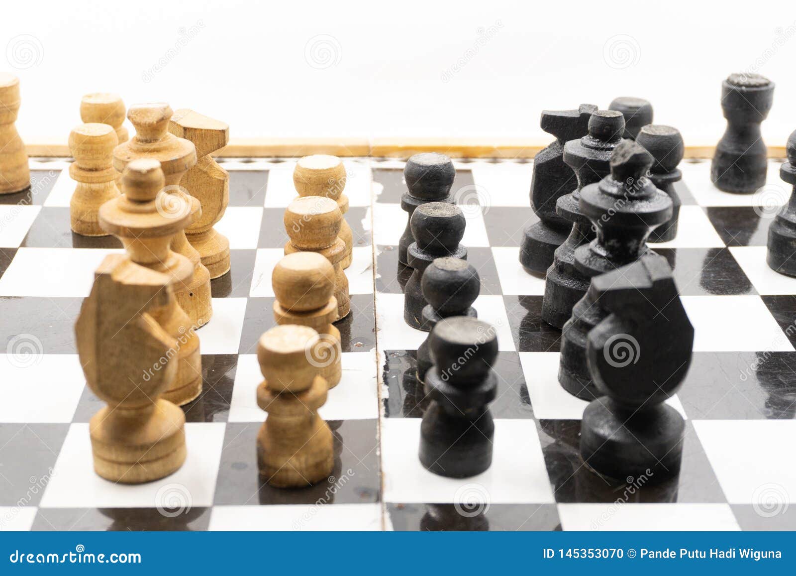 Two Sides of Black and White Chess Pieces, Which are Made of Wood, are ...