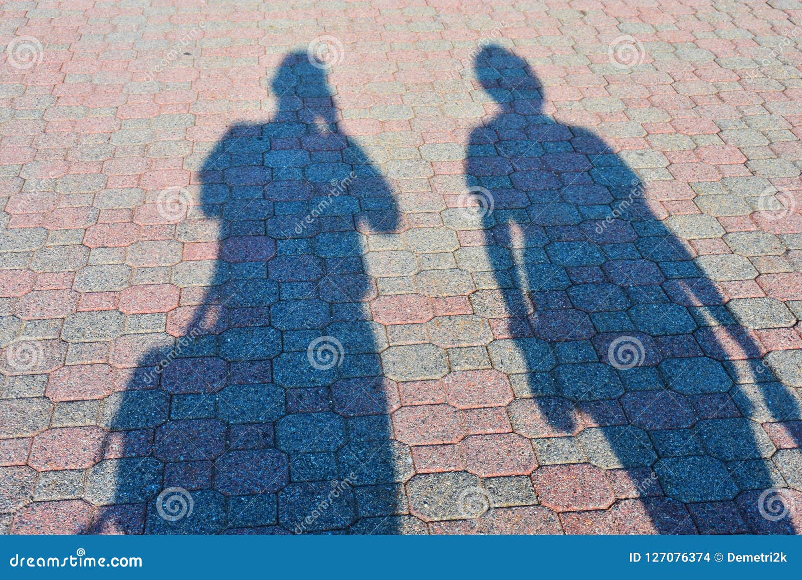 Two Silhouettes on a Brick Paved Path Stock Photo - Image of asphalt ...