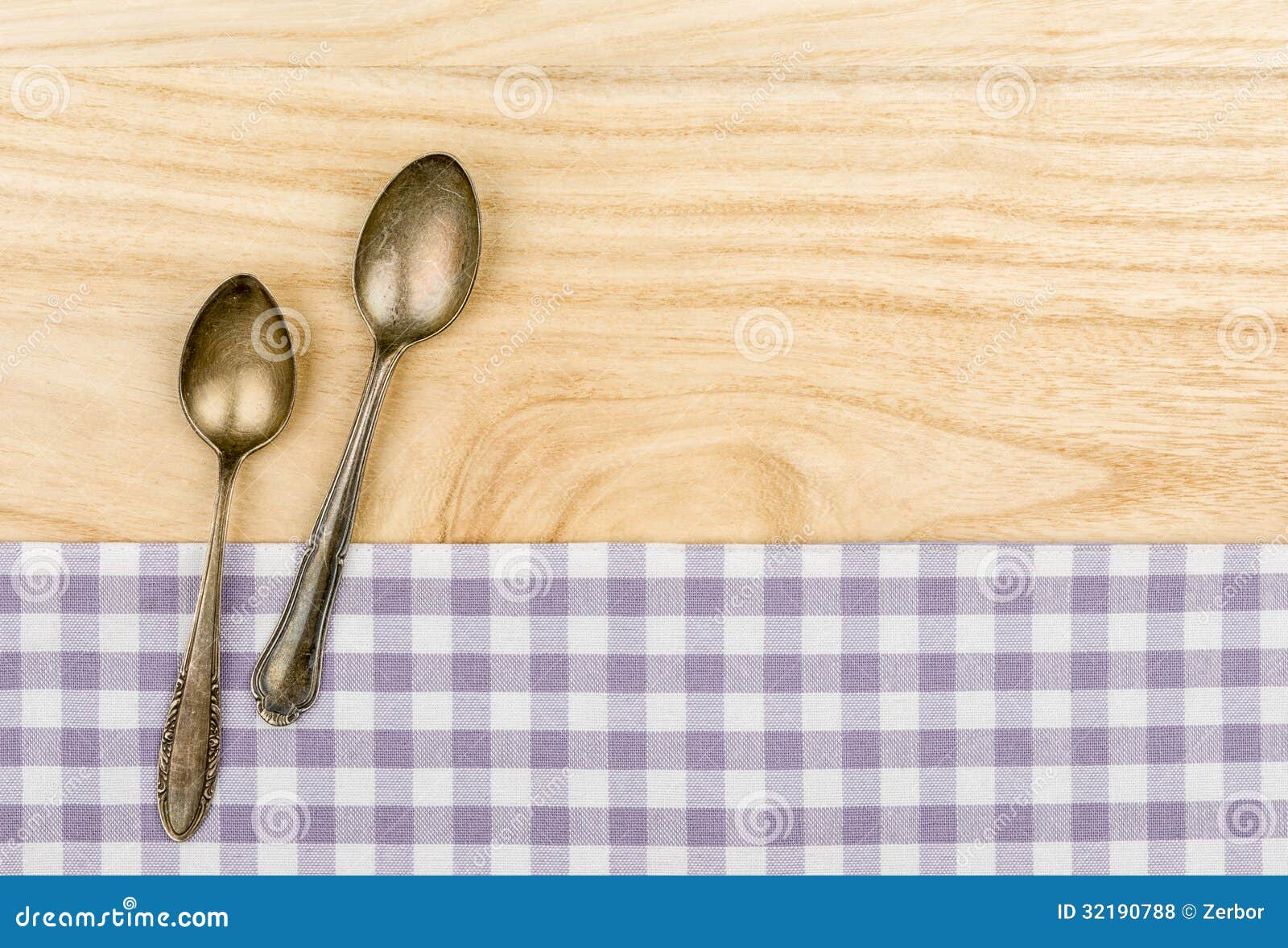 Two Silver Spoons on a Purple Checkered Table Cloth Stock Photo - Image ...
