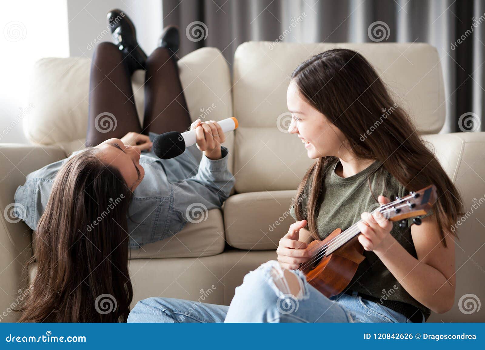 Two Sisters Alone in the House Having Fun and Playing Stock Photo ...