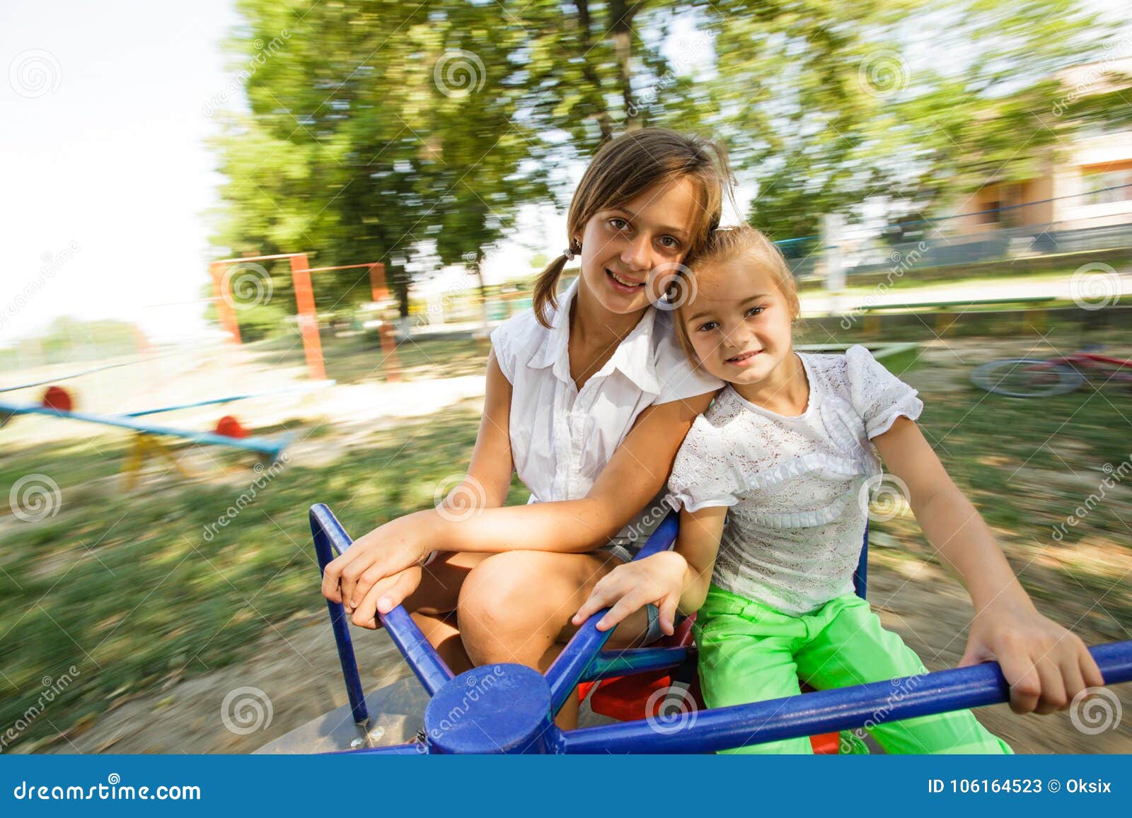 Two Sisters on the Carousel Stock Image - Image of happy, motion: 106164523