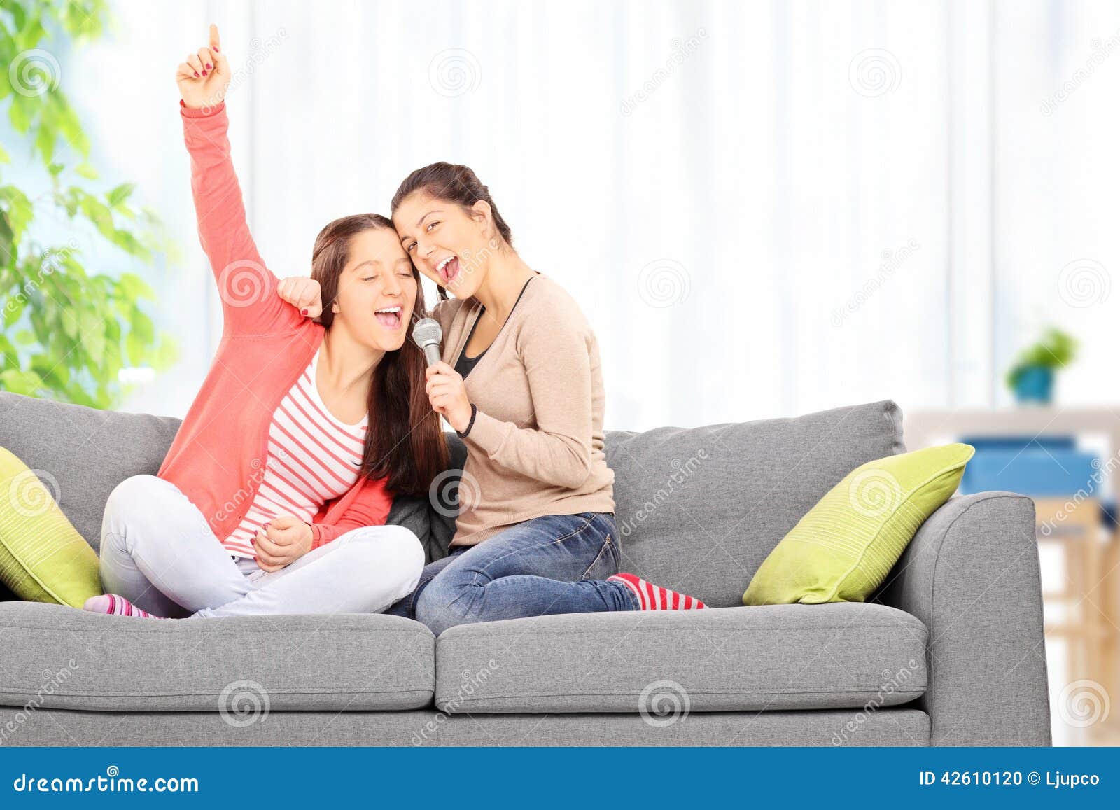 Two Sisters Having Fun Singing on Microphone Stock Photo - Image of ...