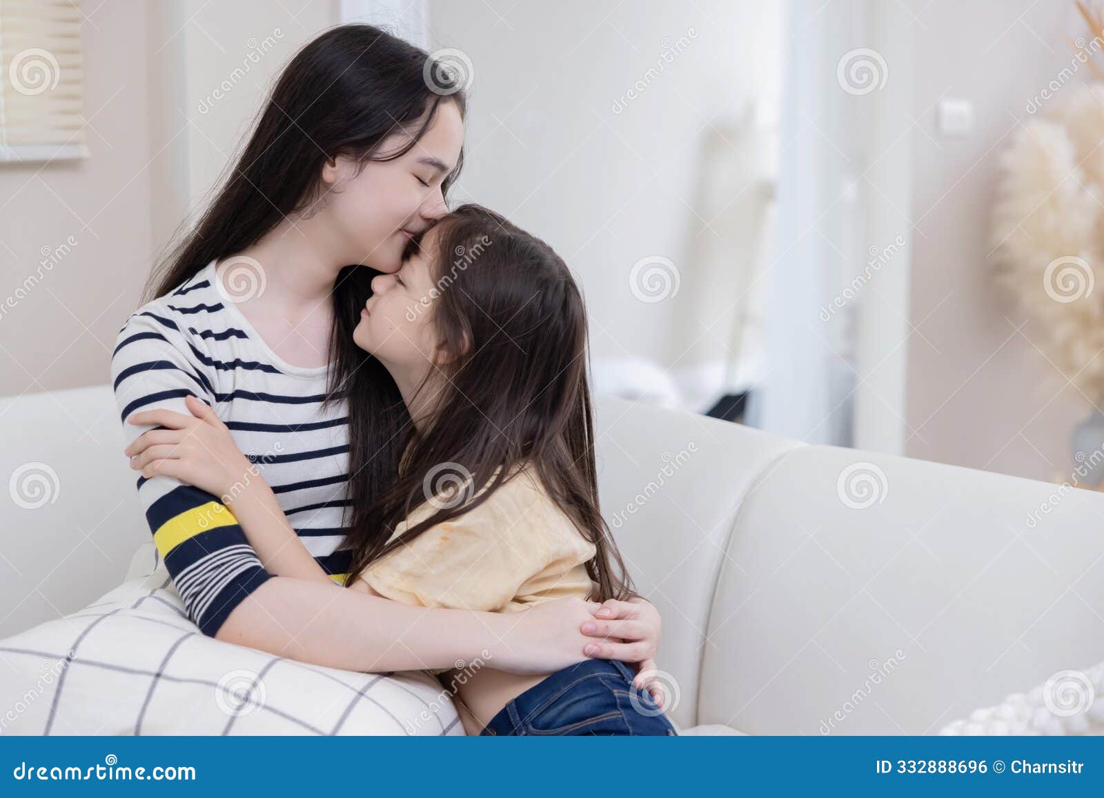Two Sisters Hug Each Other with Love on the Couch Stock Photo - Image ...