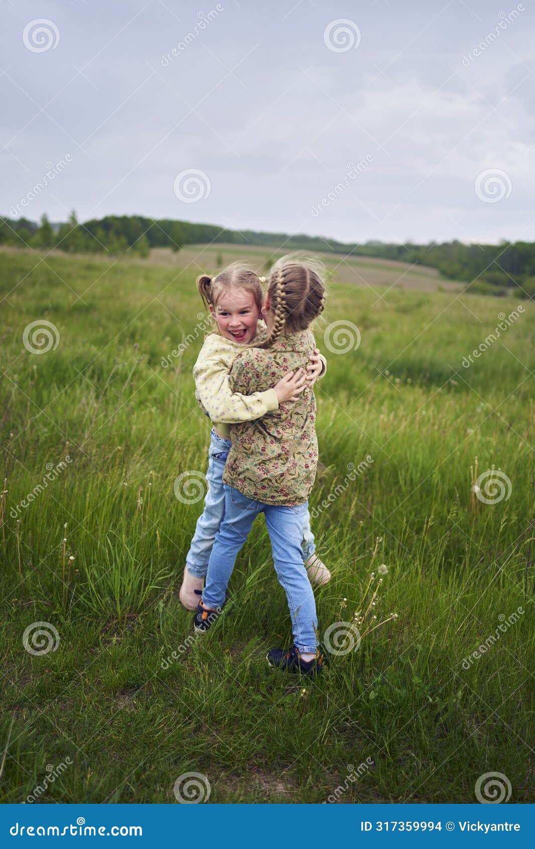Two Sisters Hug and Kiss in the Field Stock Photo - Image of playing ...