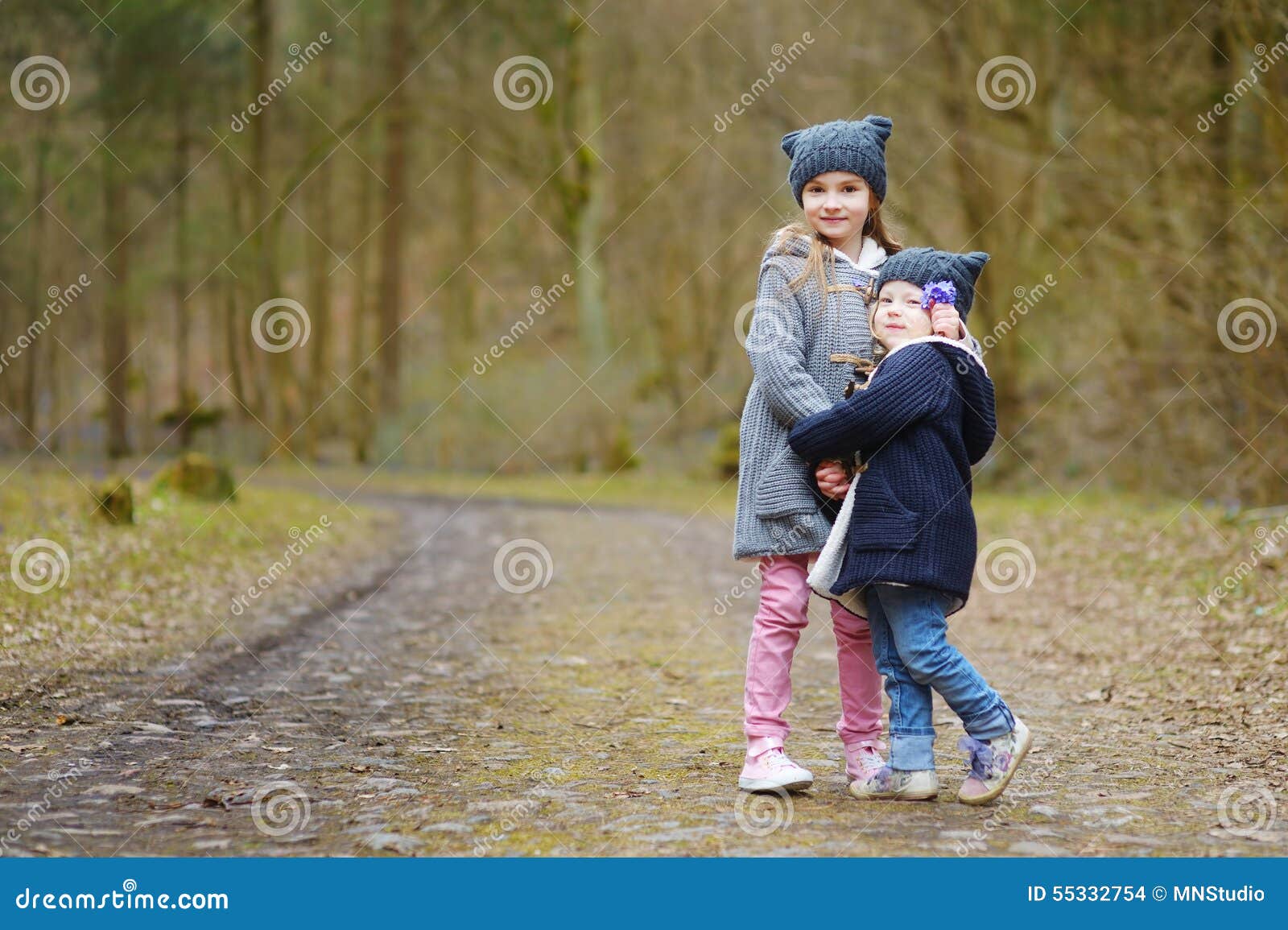 Two Sisters Picking the First Flowers of Spring Stock Photo - Image of ...