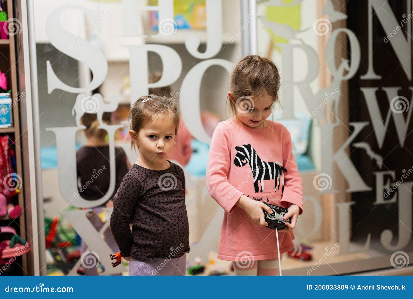 Two Sisters Play Remote Control in Children`s Room Stock Image - Image ...
