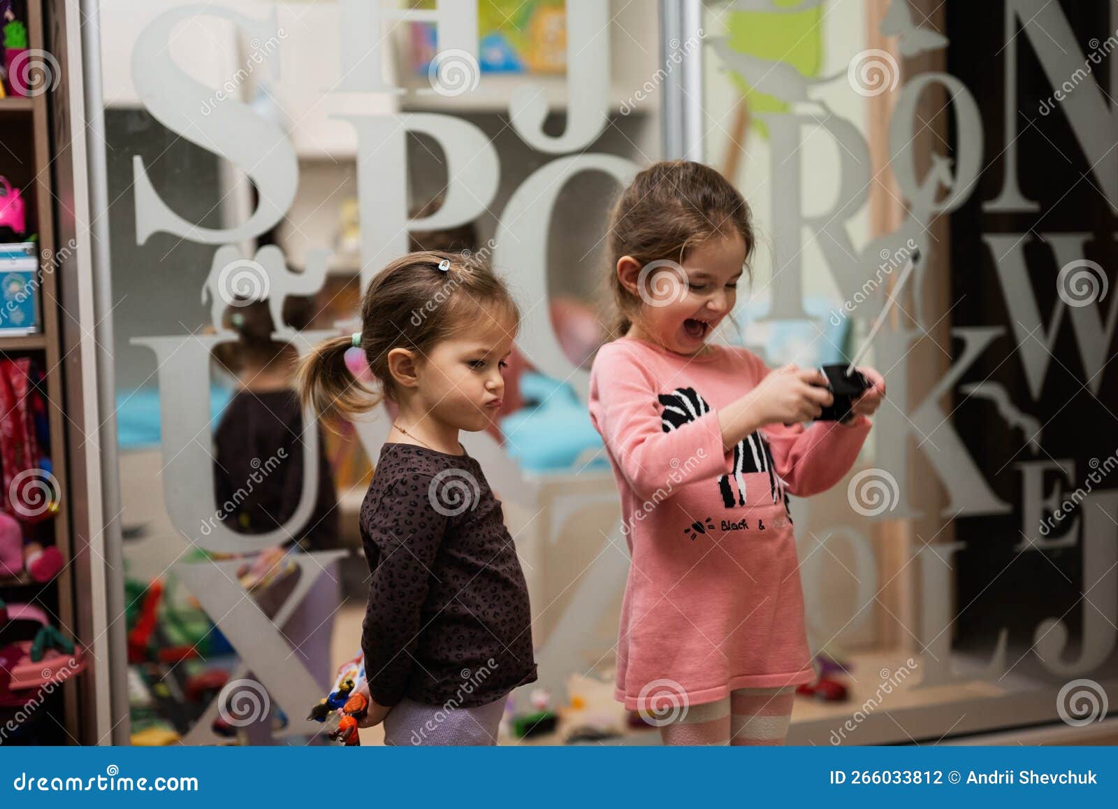 Two Sisters Play Remote Control in Children`s Room Stock Photo - Image ...
