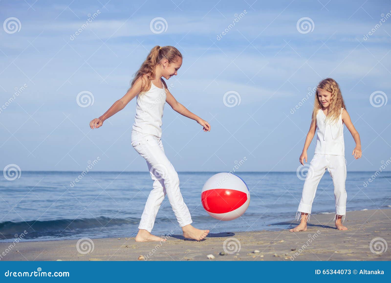 Two Sisters Playing on the Beach at the Day Time. Stock Image - Image ...