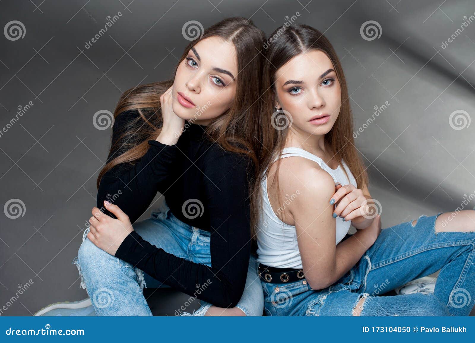 Two Sisters Posing Facing in Different Directions, Concept of Opposite ...