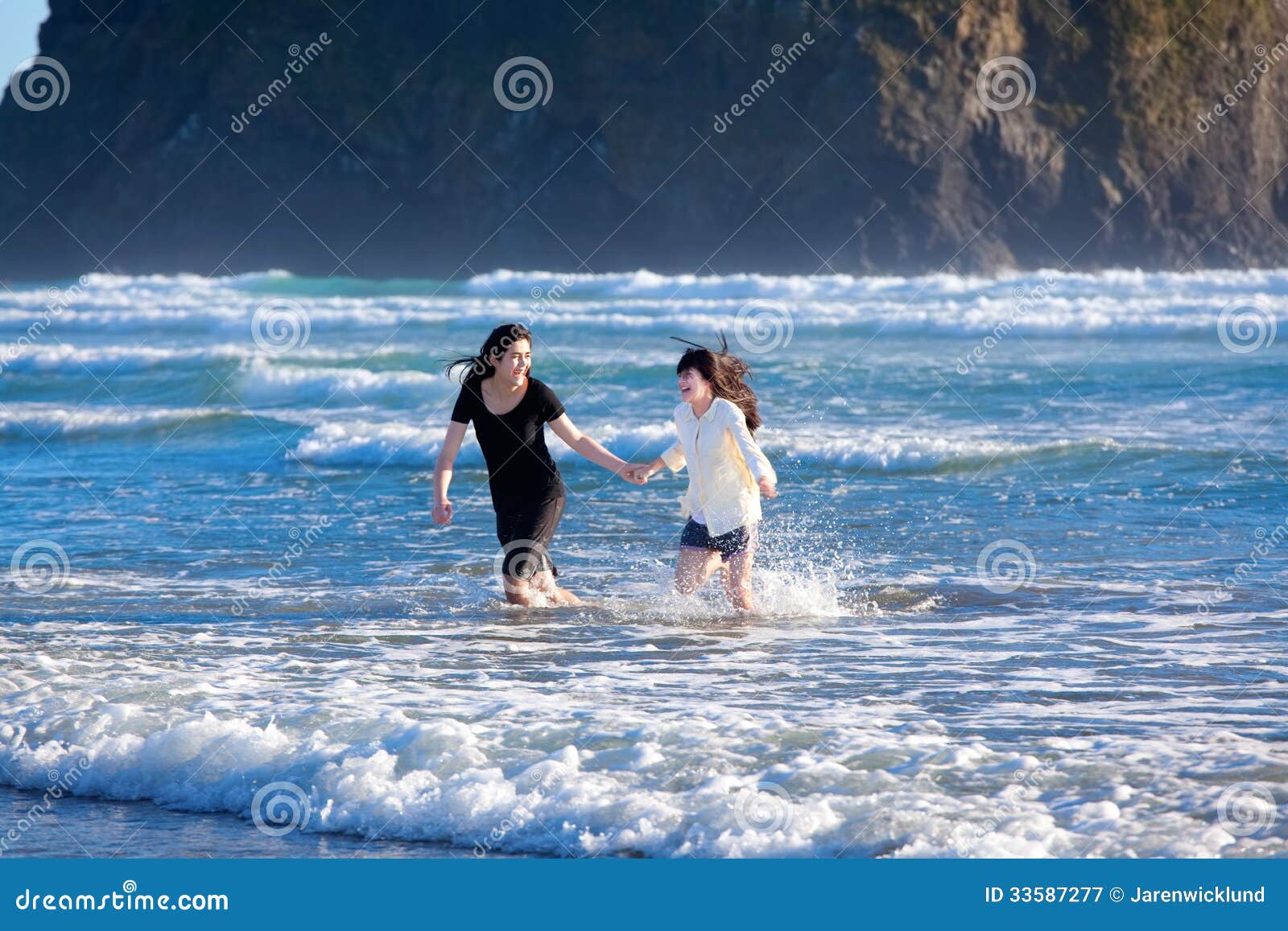 Two Sisters Running in Ocean Waves Stock Image - Image of pacific ...