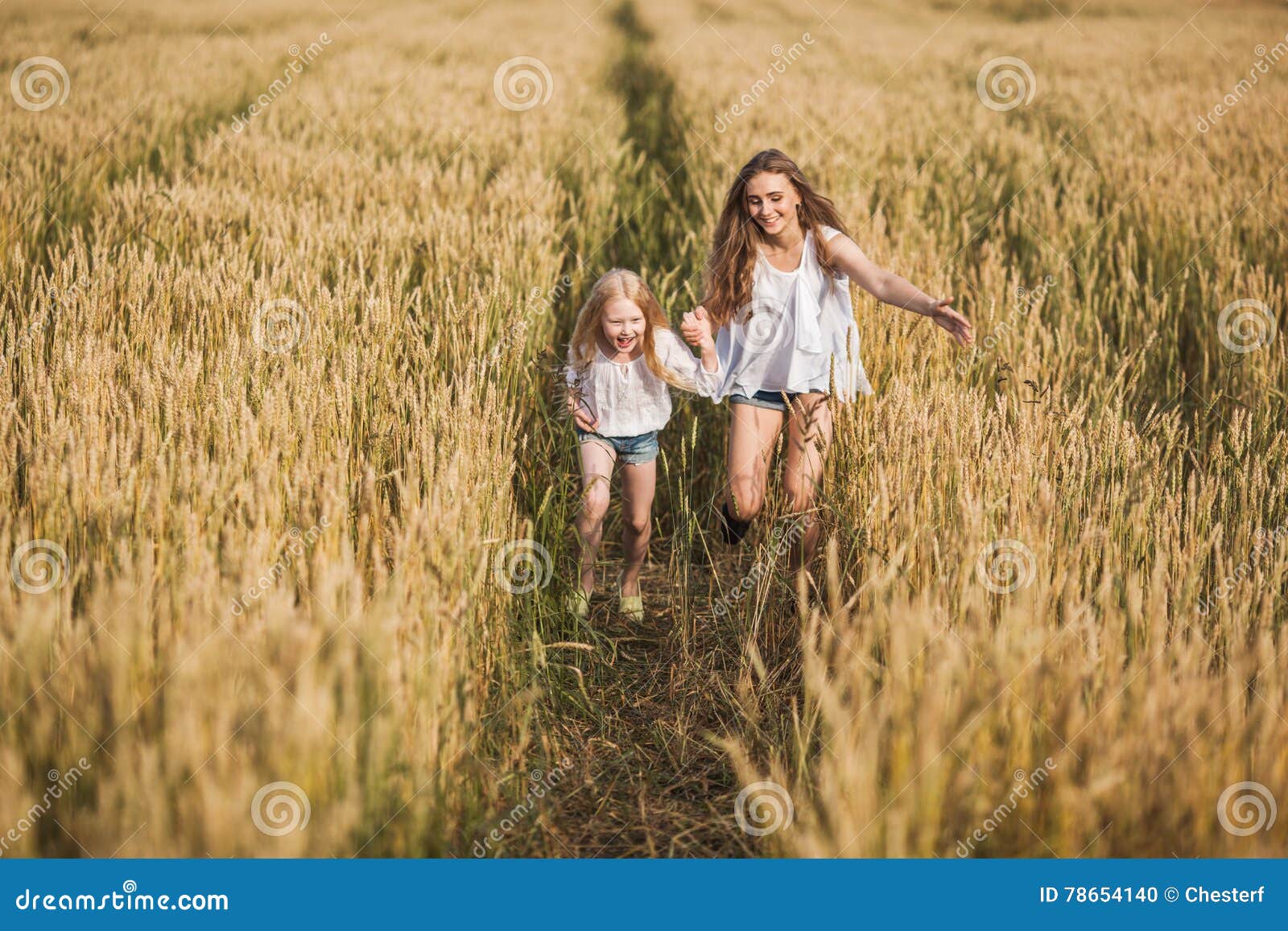 Two Sisters Running on Wheat Filed Stock Photo - Image of happy ...