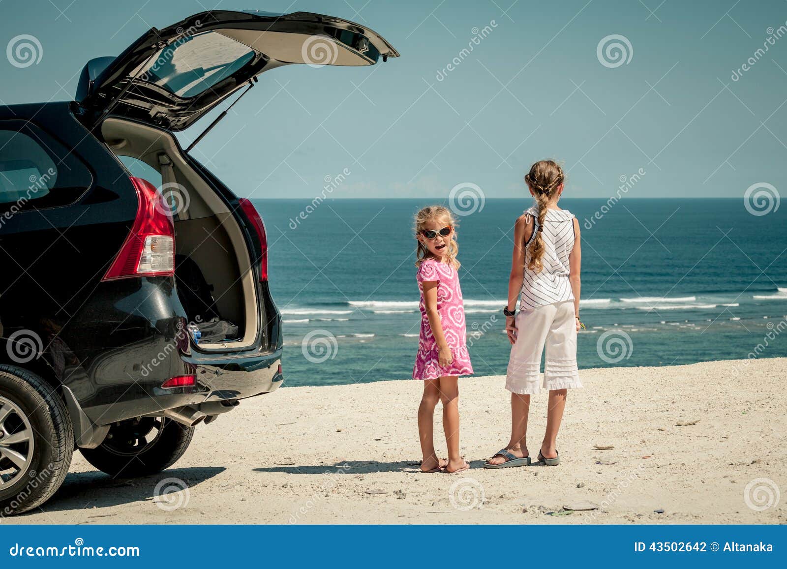 Two Sisters Standing Near a Car on the Beach Stock Photo - Image of ...