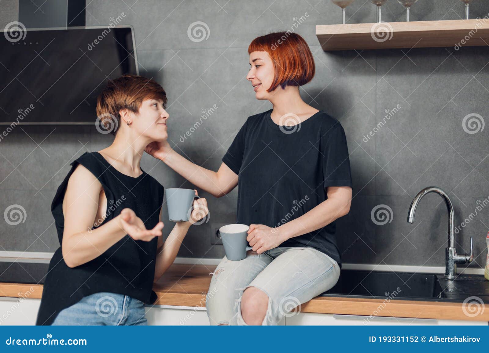 Two Sisters are Talking in the Kitchen while Drinking Tea Stock Photo ...