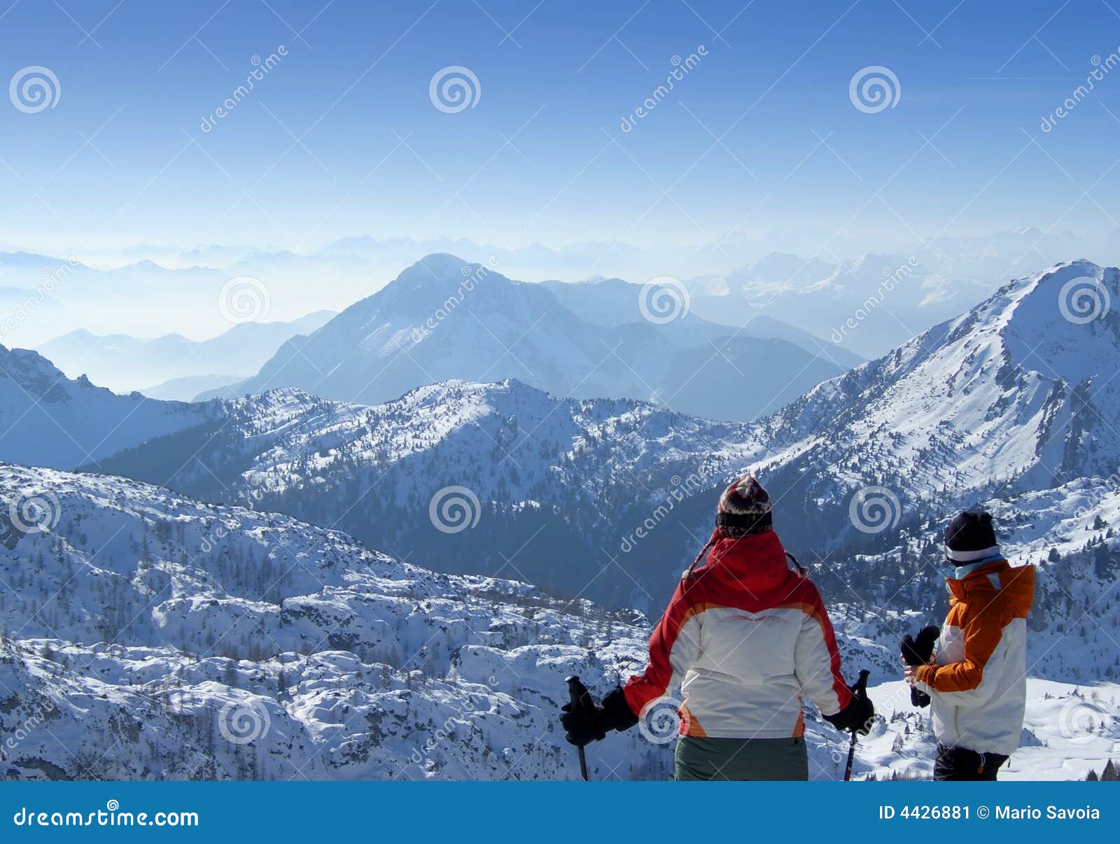 Two Skiers Looking Over Mountains Top Stock Image - Image of mountain ...