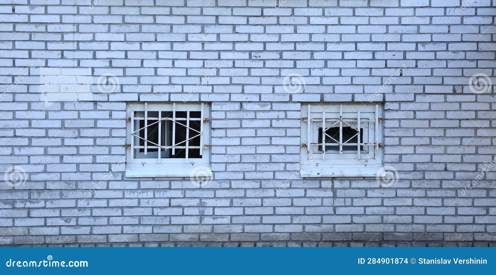 Two Small Barred Windows in a White Brick Wall Stock Photo - Image of ...