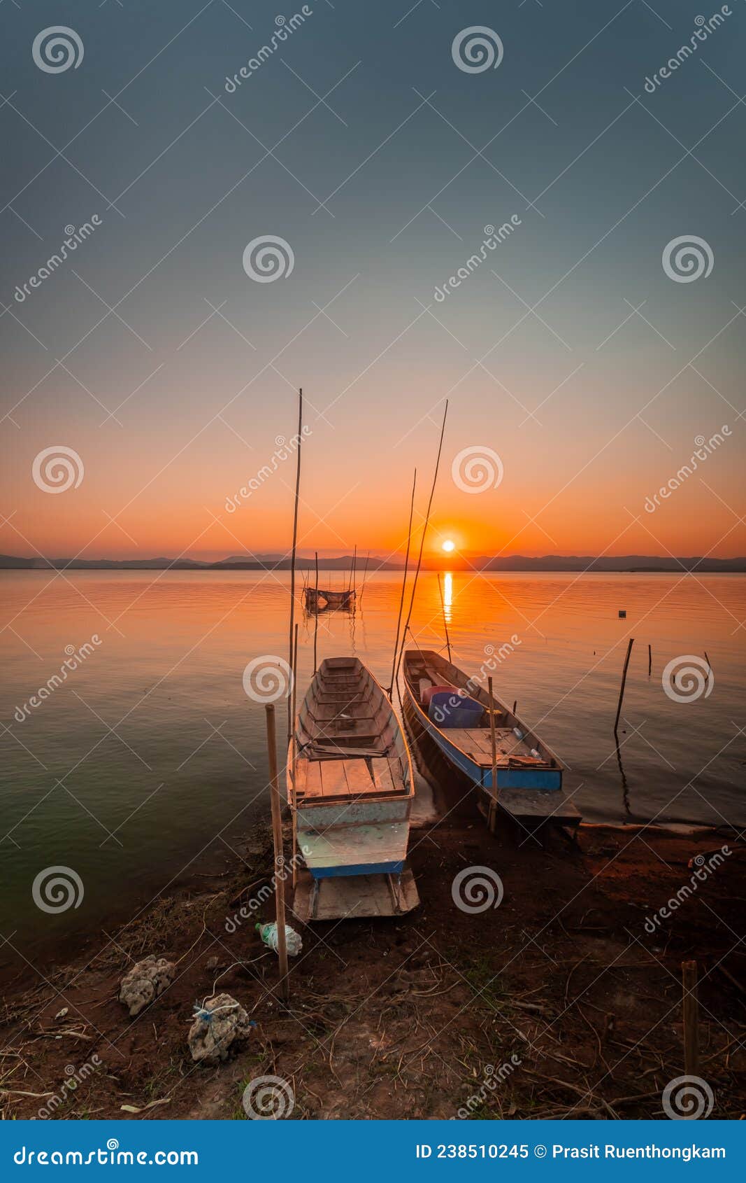 Two Small Boats Moored on the Shore of the Lake. at Sunset Editorial ...