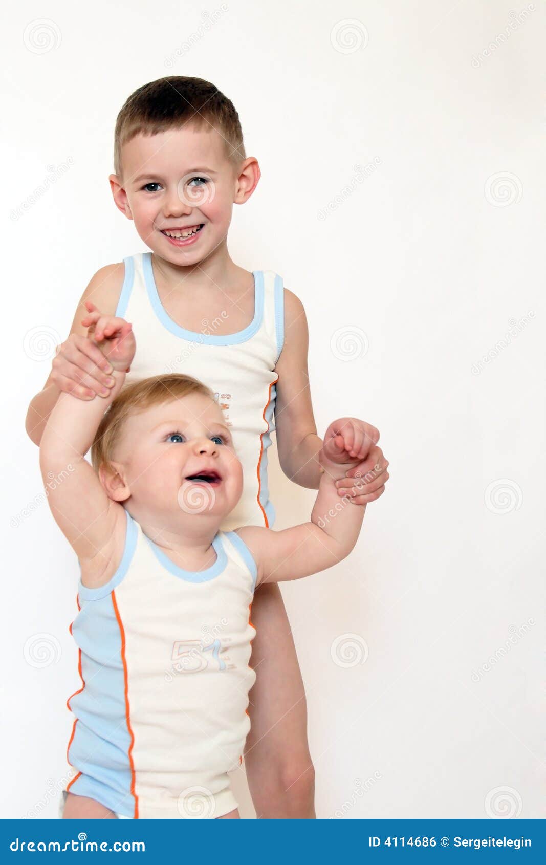 Two Small Boys in Identical Clothes Stock Photo - Image of emotions ...