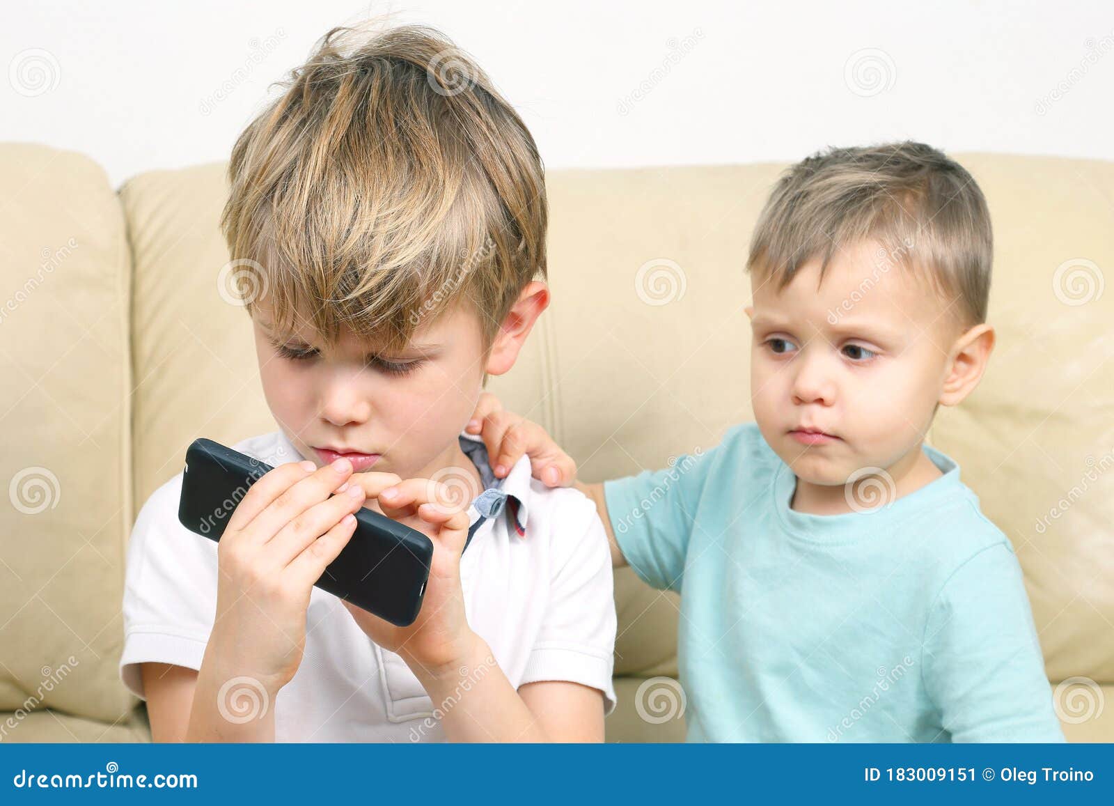 Two Small Boys Looking at Cell Phone Stock Image - Image of indoors ...