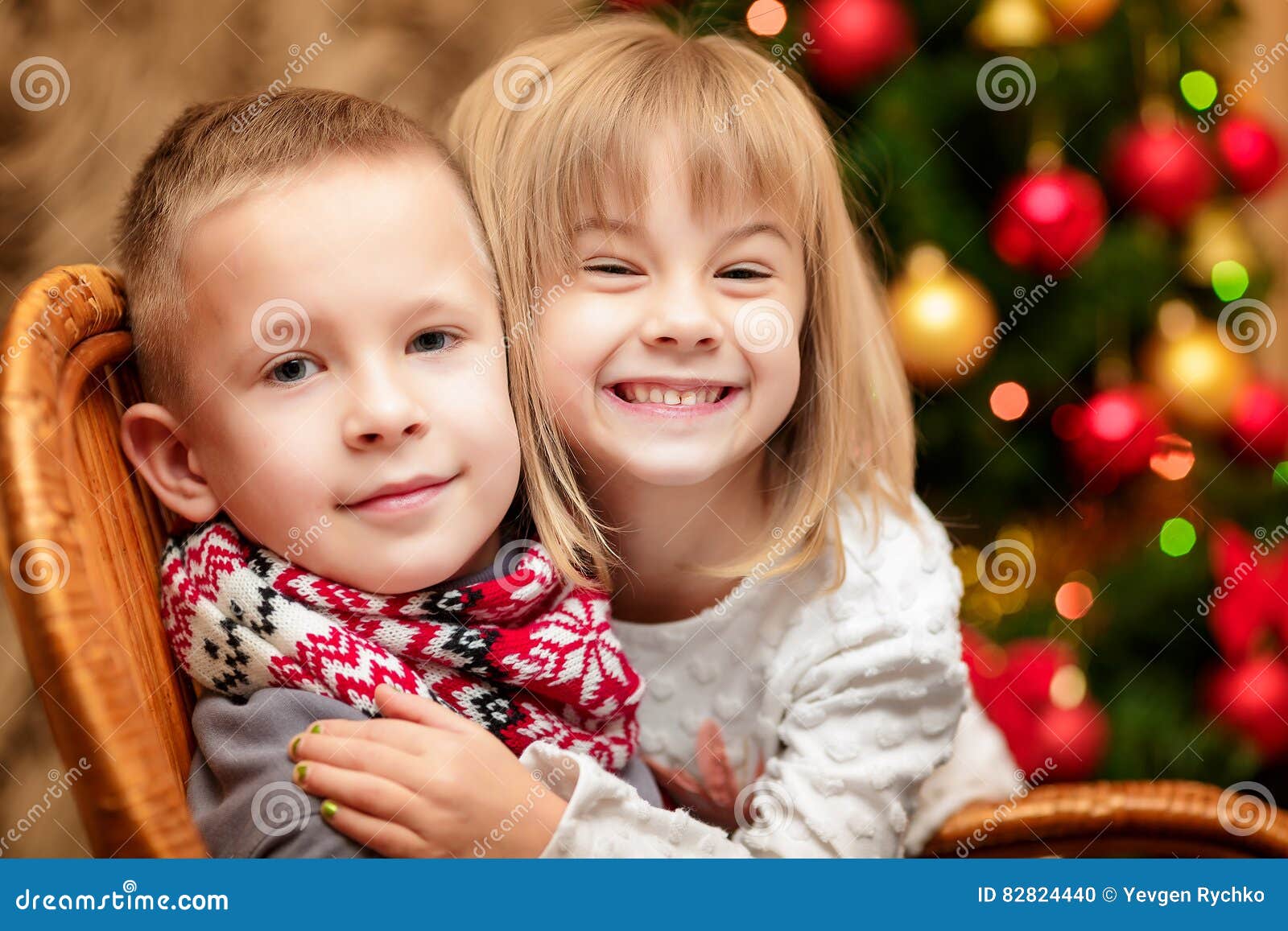 Two Small Children in the Background of the Christmas Tree Stock Photo ...