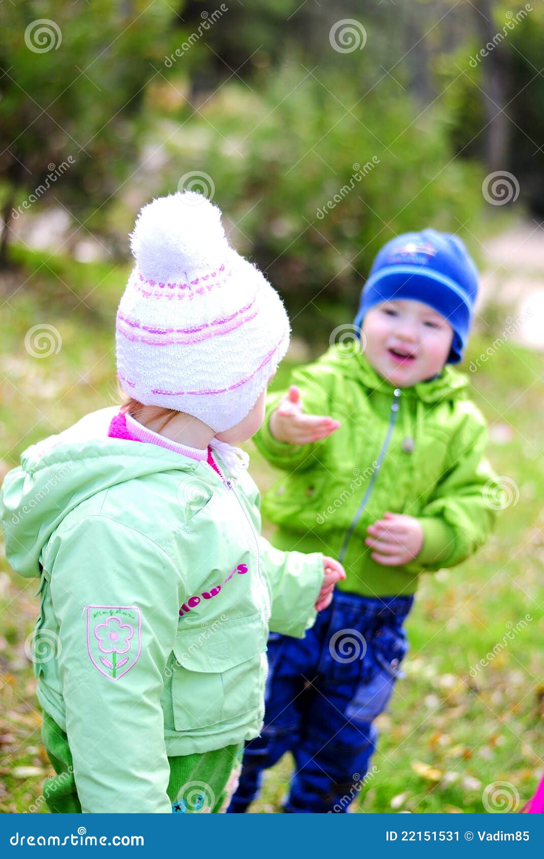 Two Small Children Sit on a Green Clearing Stock Image - Image of ...