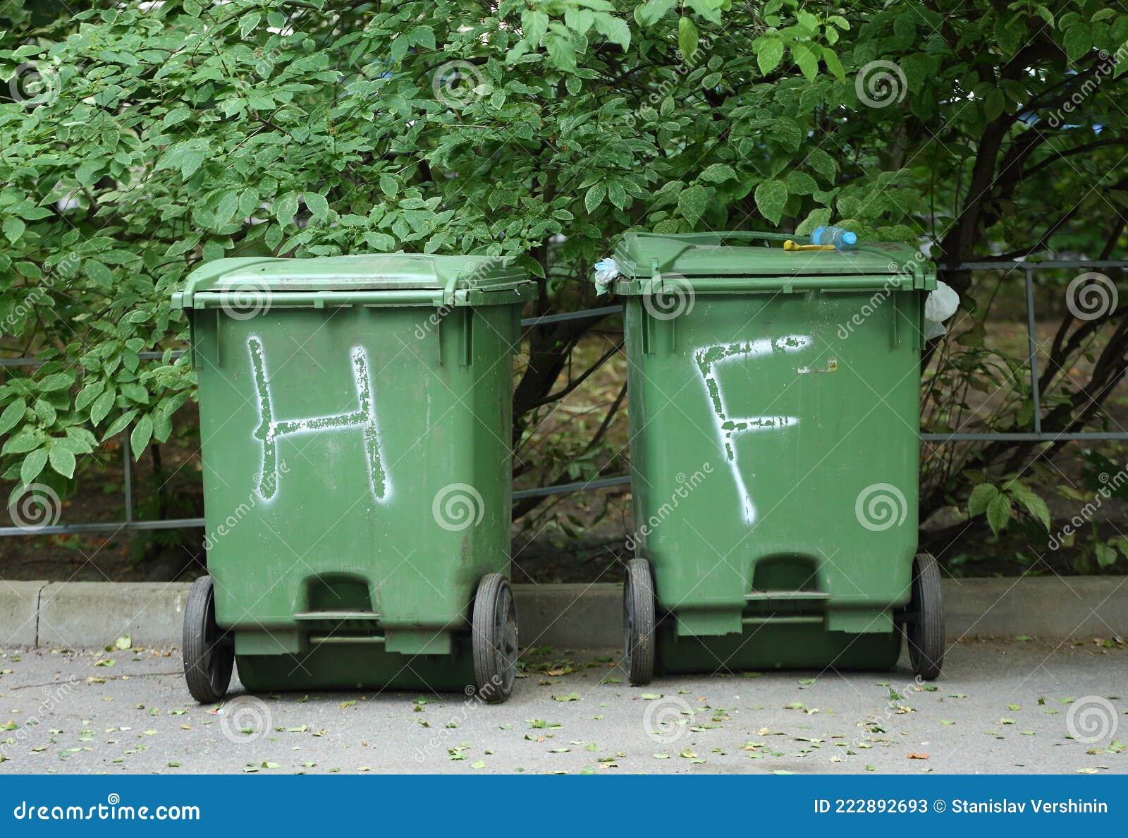 Two Small Green Plastic Mobile Garbage Containers on the Street Stock ...