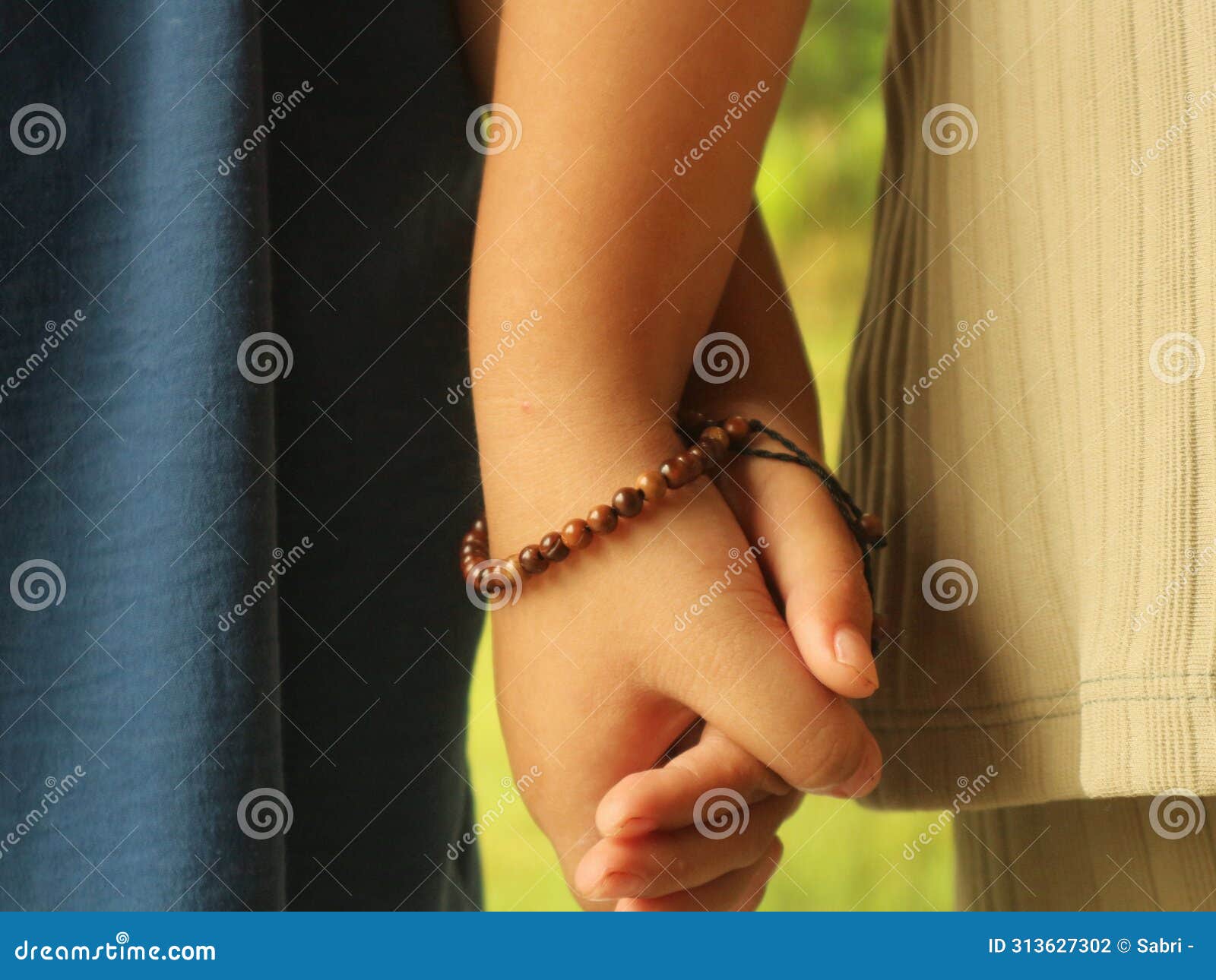 Hands holding each other. stock photo. Image of background - 313627302