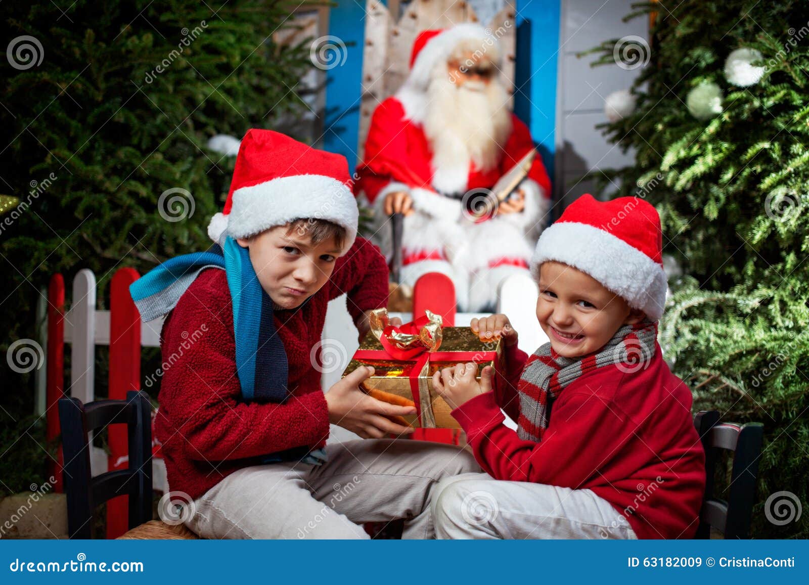 Two Small Santa Clauses Contending a Gift Stock Image - Image of ...