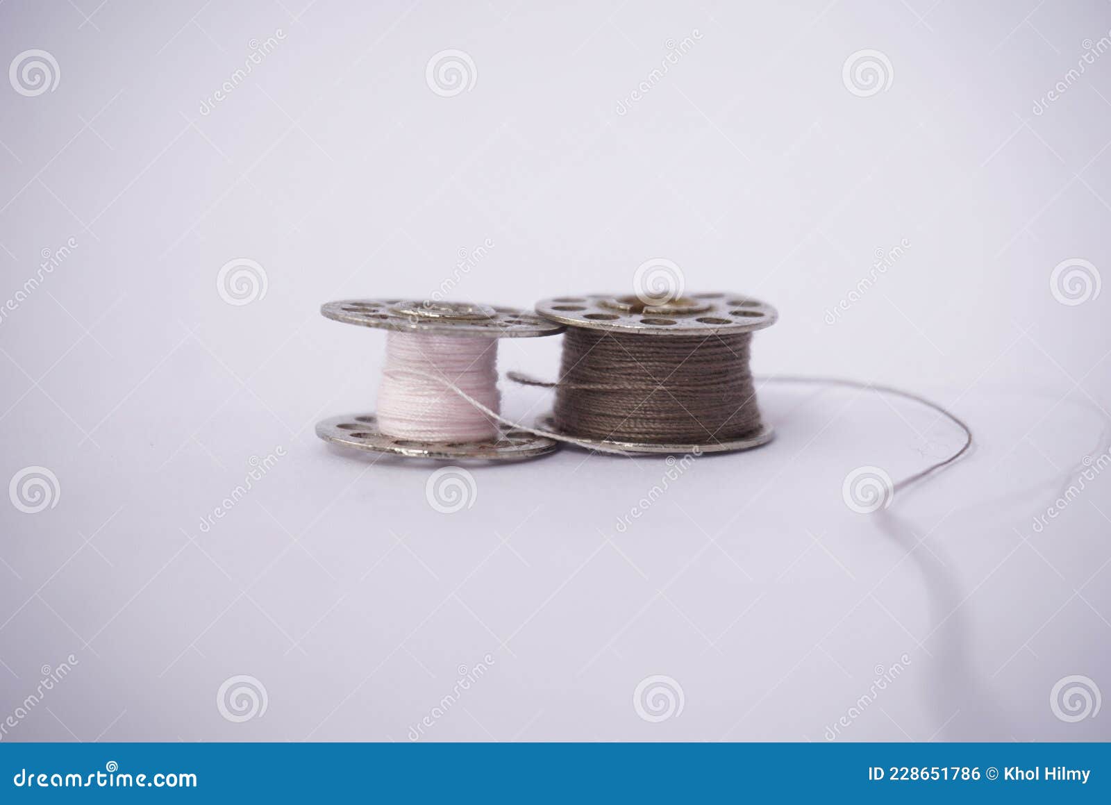 Two Small Spools of Sewing Thread of Various Colors Isolated on a White ...