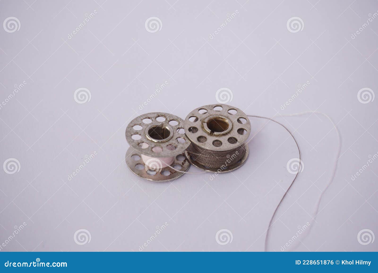 Two Small Spools of Sewing Thread of Various Colors Isolated on a White ...