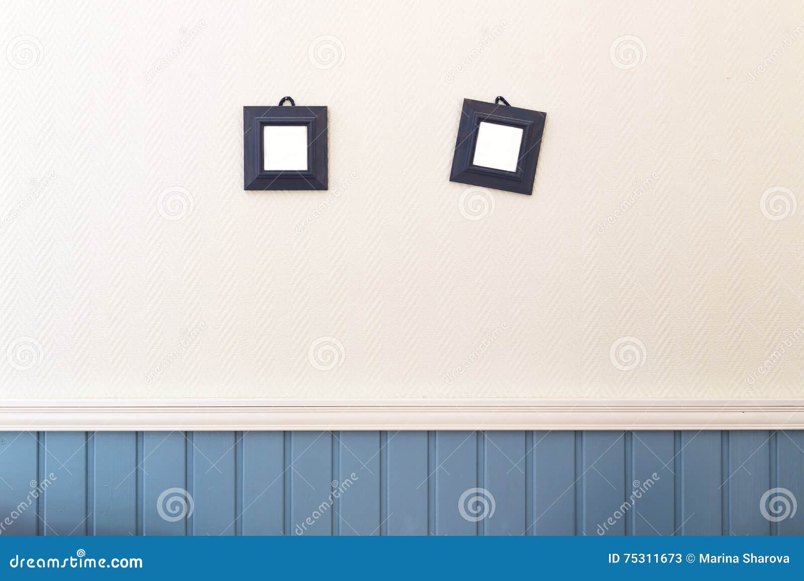 Two Small Square Frames Hanging on the White and Blue Wall. Stock Image ...