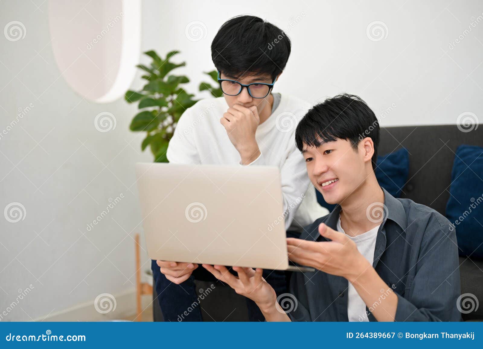 Two of Smart Young Asian Male College Students Doing School Project ... Two of Smart Young Asian Male College Students Doing School Project ...