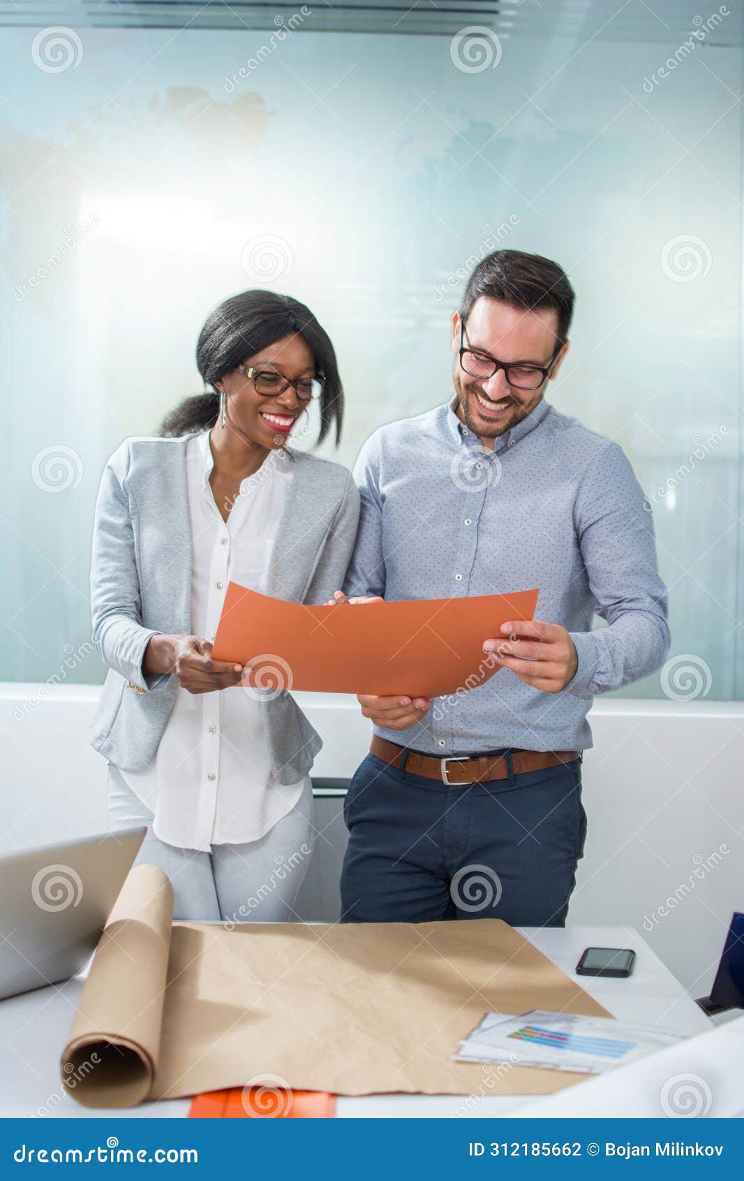Two Smiling Architects Working Together on a Building Project Stock ...