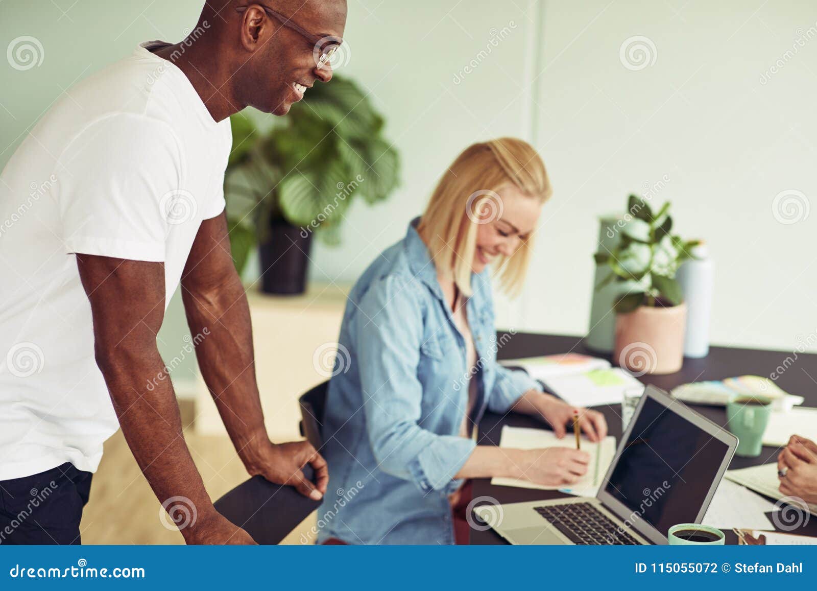 Two Smiling Business Colleagues Working Together in an Office Stock ... Two Smiling Business Colleagues Working Together in an Office Stock ...