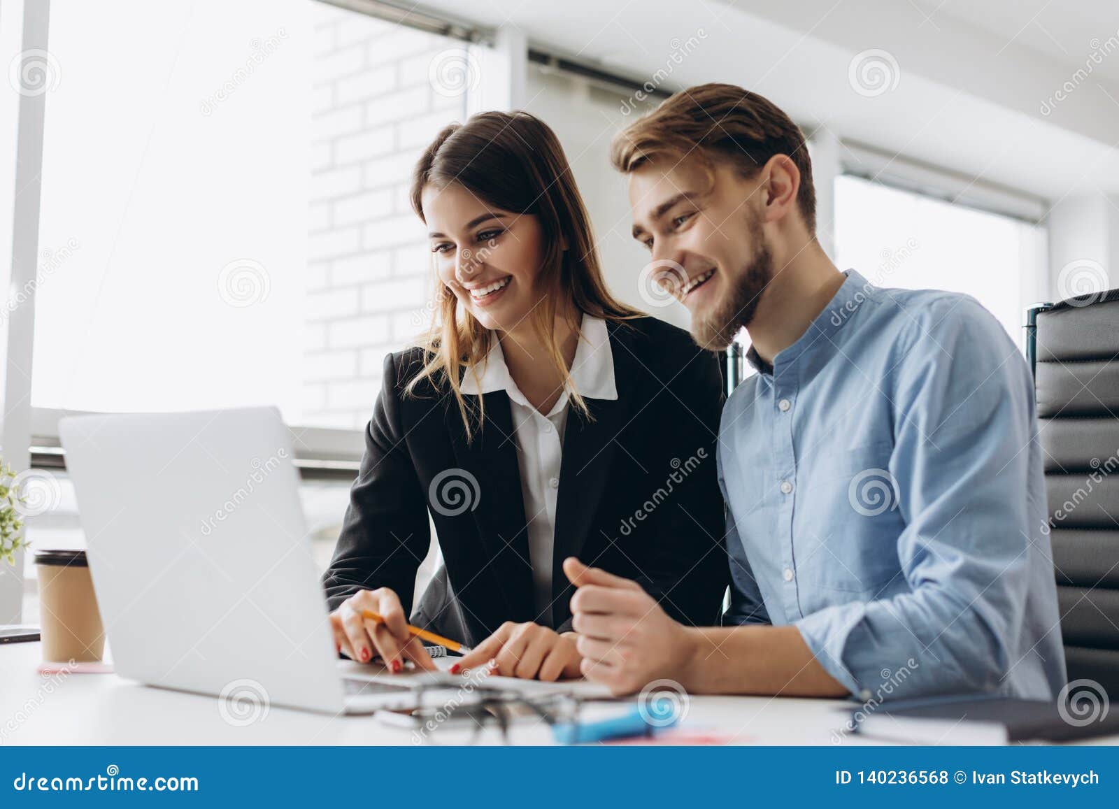 Two Smiling Businesspeople Sitting Together at a Table in a Modern ...