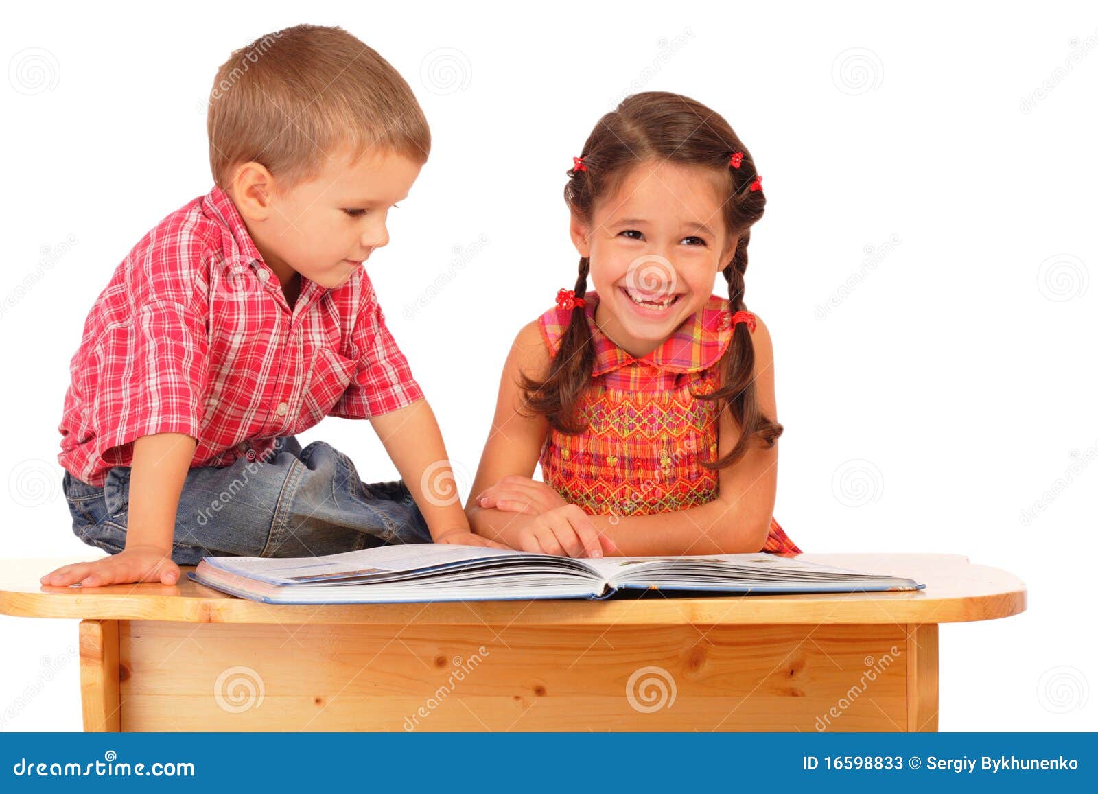 Two Smiling Children Reading the Book on the Desk Stock Image - Image ...