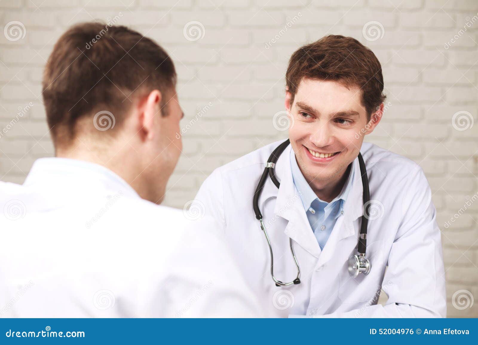 Two Smiling Doctors Discussing Something Stock Photo - Image of ...