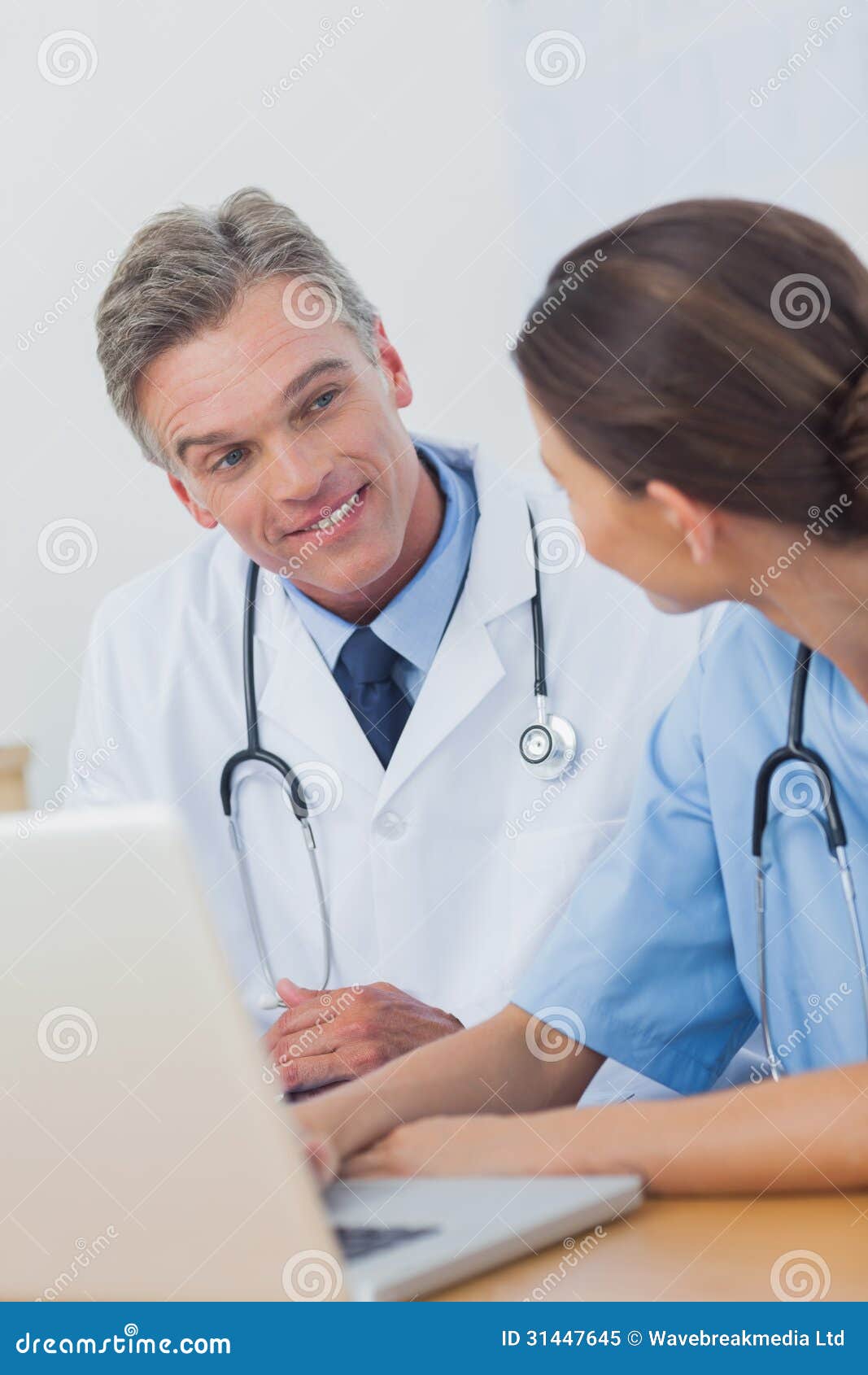 Two Smiling Doctors Working on a Laptop Stock Image - Image of mature ...