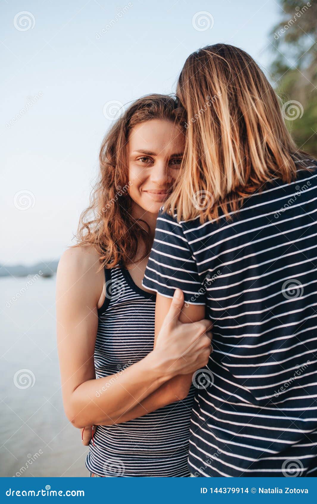 Two Smiling Friends Hugging Each Other on the Beach Stock Photo - Image ... Two Smiling Friends Hugging Each Other on the Beach Stock Photo - Image ...