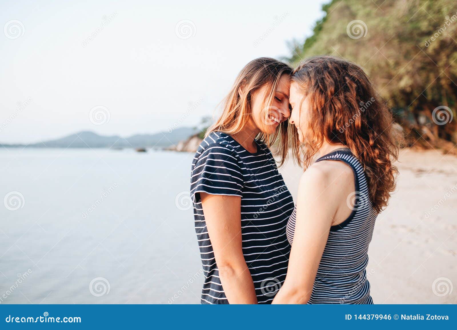 Two Smiling Friends Hugging Each Other on the Beach Stock Photo - Image ... Two Smiling Friends Hugging Each Other on the Beach Stock Photo - Image ...