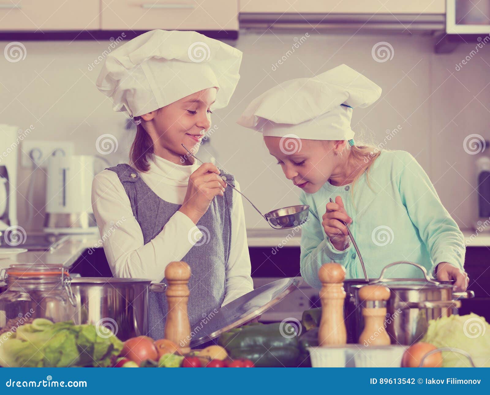 Two Smiling Girls Cooking Vegetable Soup at Home Kitchen Stock Photo ...