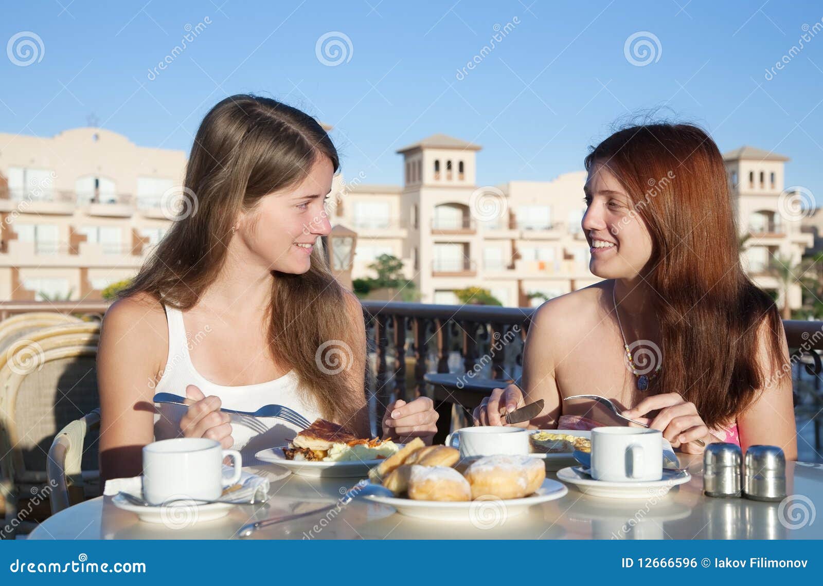 Two Smiling Girls Having Lunch Stock Photo - Image of bake, pastry ...