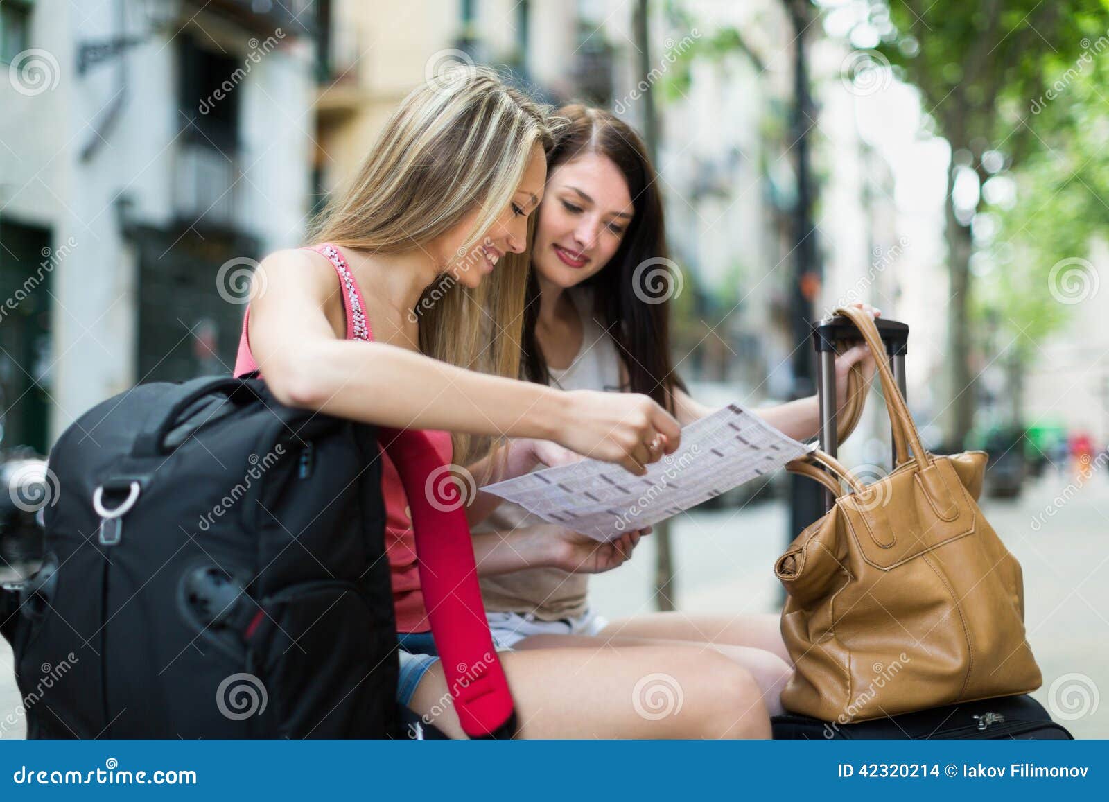 Two smiling girls with map stock photo. Image of route - 42320214