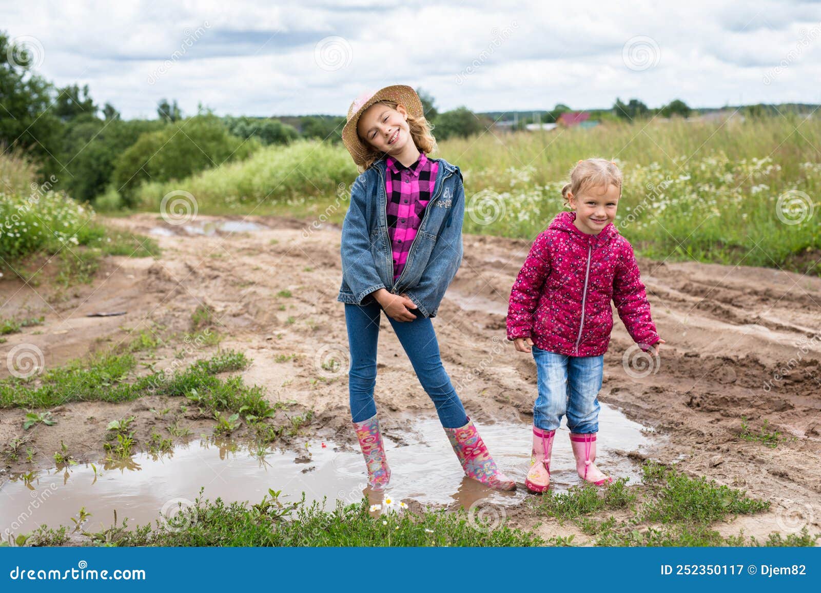 Two Girls Run through the Puddles and Play. Stock Image - Image of ...