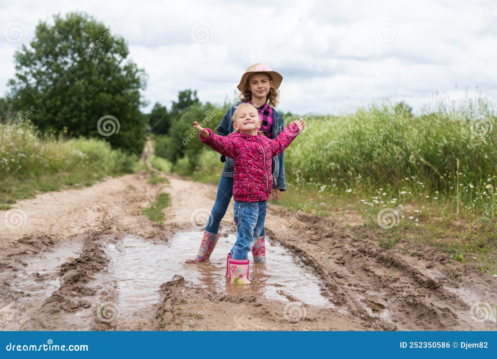 Two Girls Run through the Puddles and Play. Stock Photo - Image of play ...